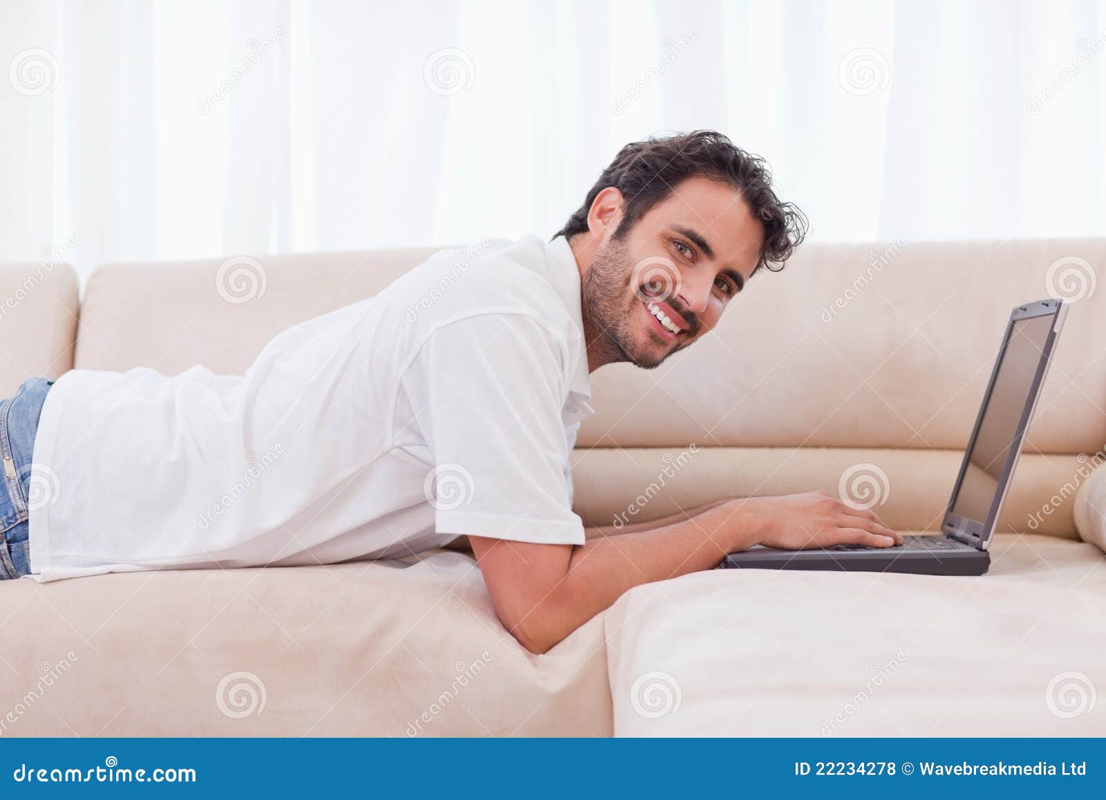 Smiling Man Using a Notebook Stock Photo - Image of lifestyle, house ...