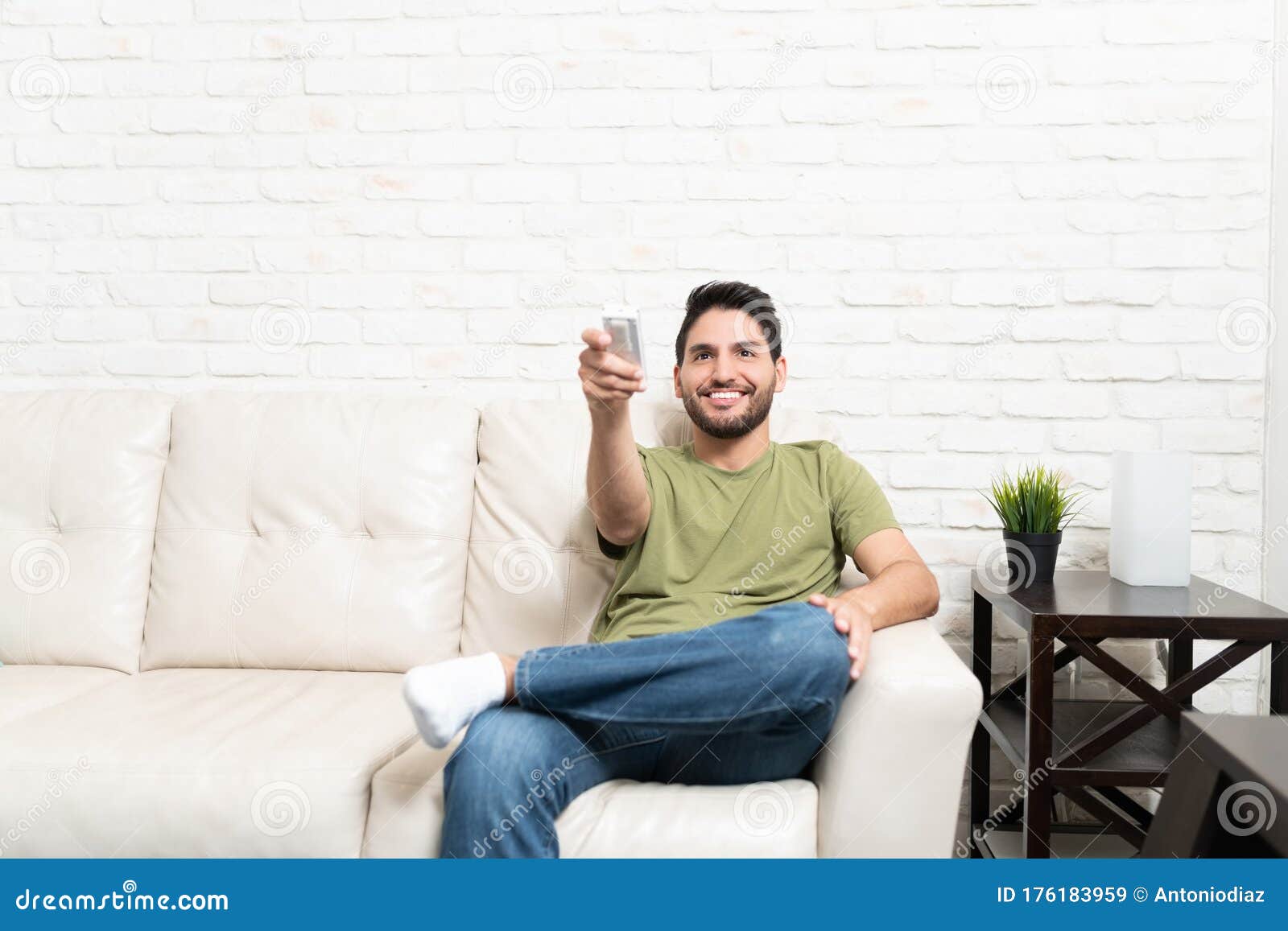 Smiling Man Using Remote Control at Home Stock Image - Image of ...