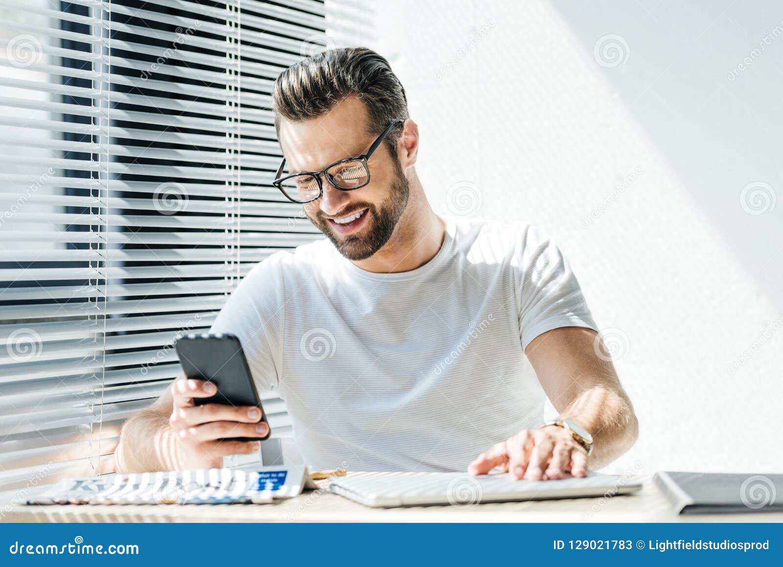 Smiling Man Using Smartphone while Sitting Stock Image - Image of ...