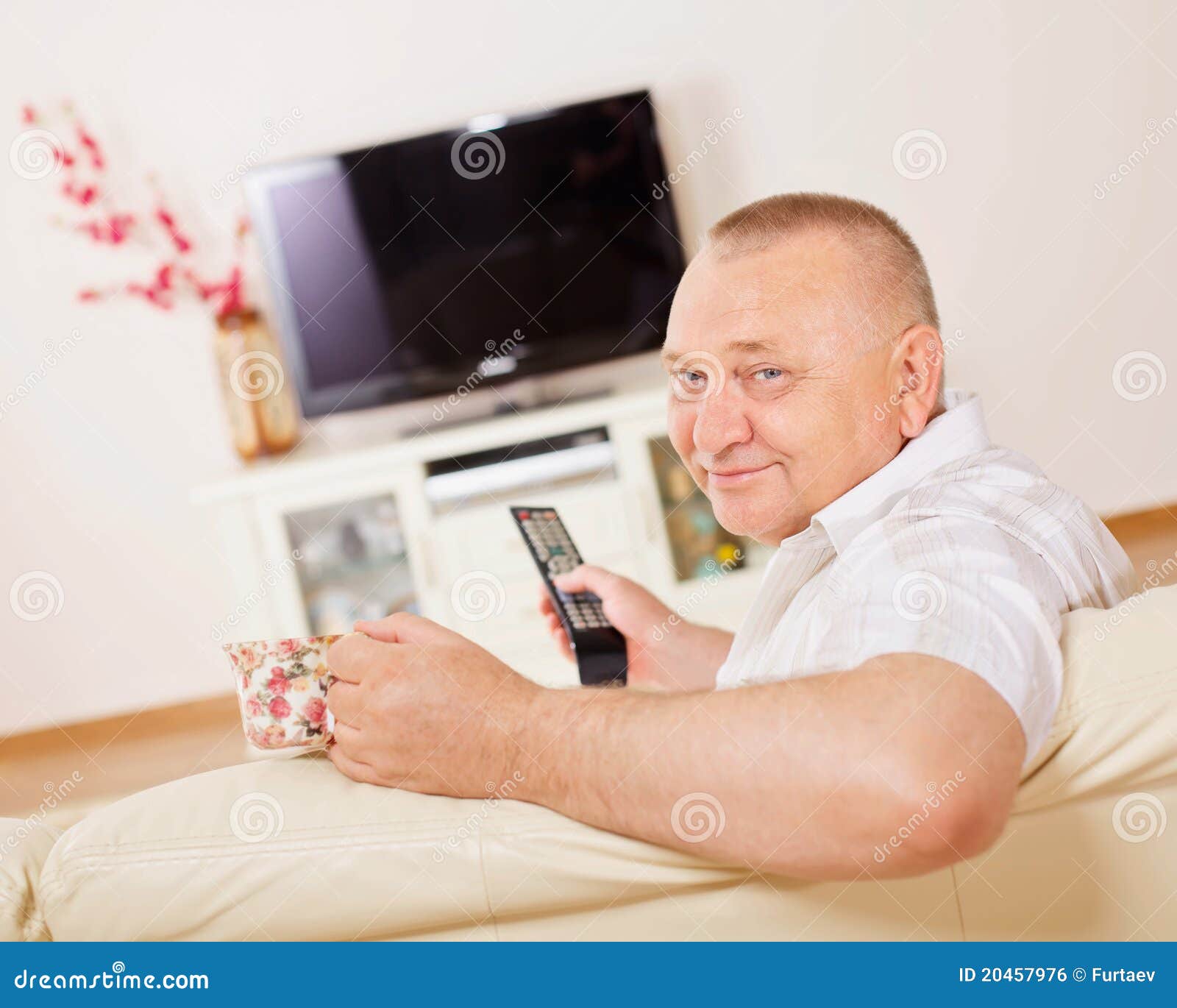 Smiling man watching TV stock photo. Image of male, holding - 20457976