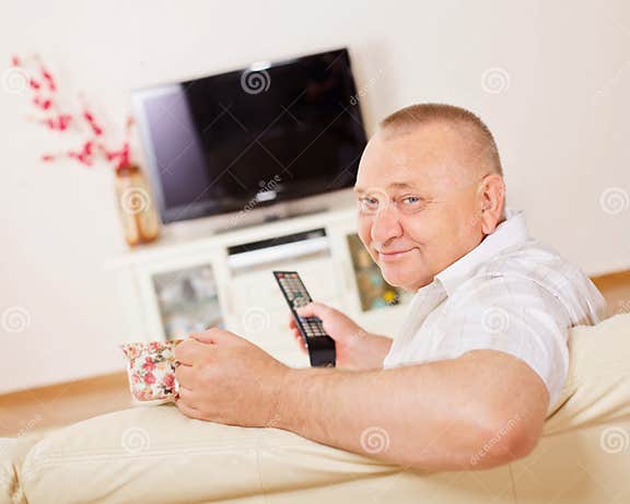 Smiling man watching TV stock photo. Image of male, holding - 20457976