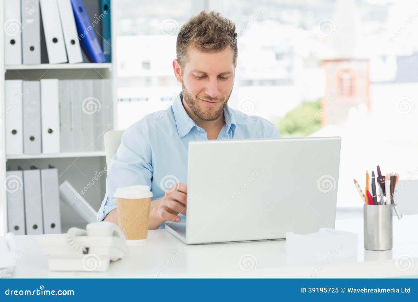 Smiling Man Working at His Desk on Laptop Stock Image - Image of office ...