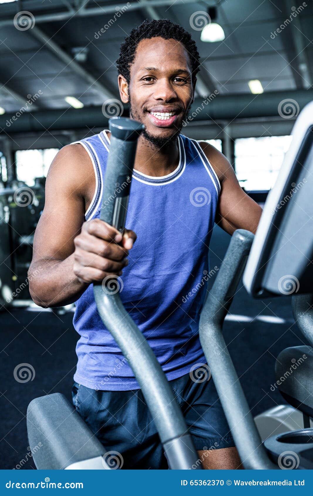 Smiling Man Working Out on the Machine Stock Photo - Image of club ...
