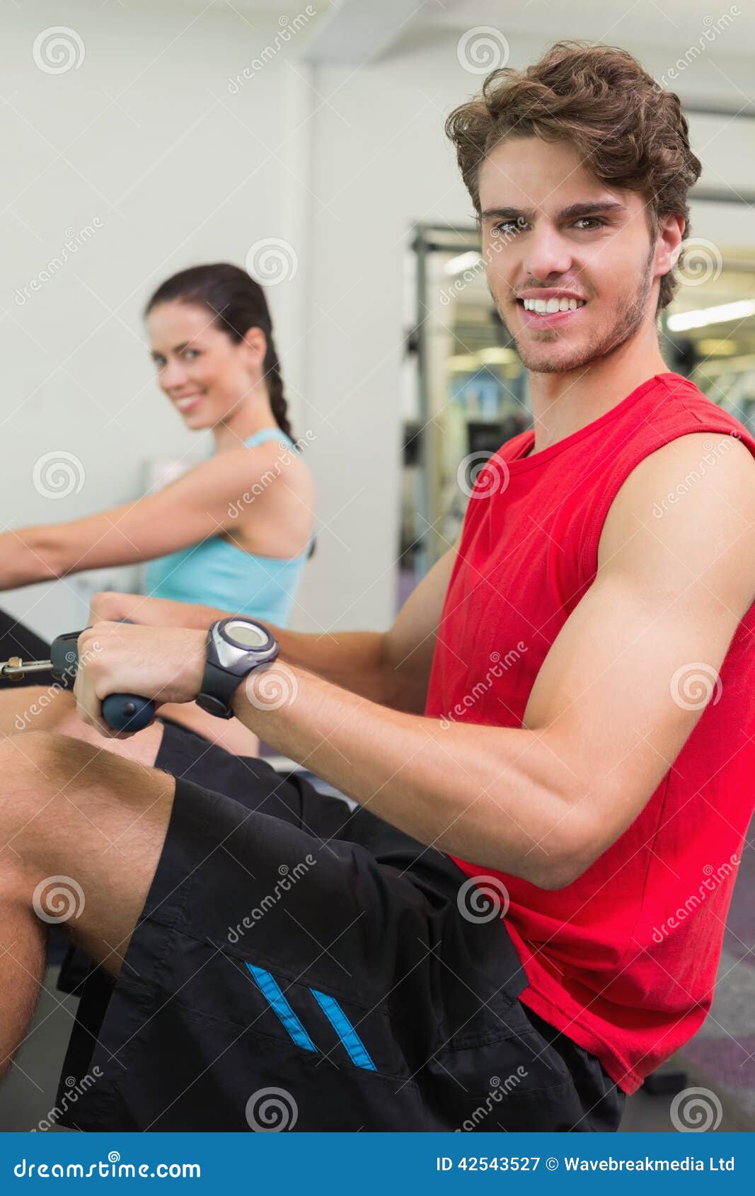 Smiling Man Working Out on the Rowing Machine Stock Image - Image of ...