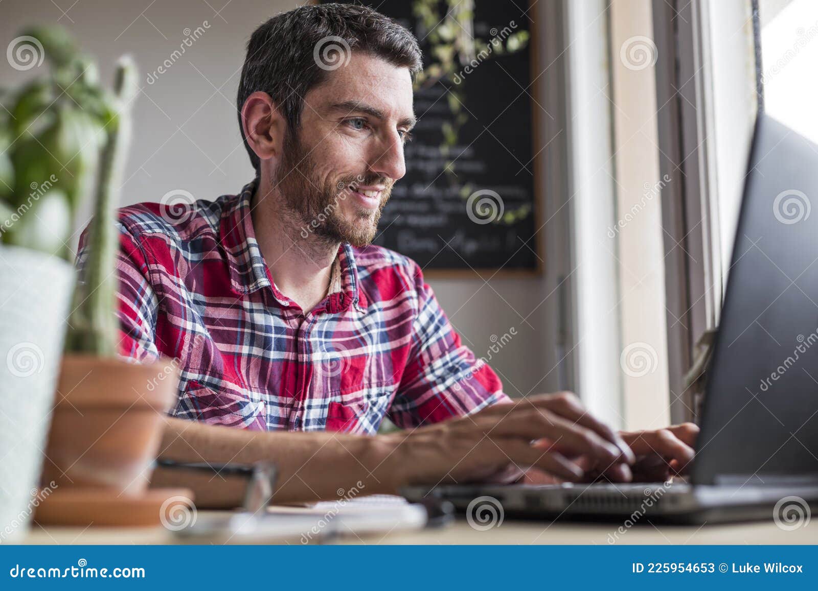 Smiling Man Writing on Laptop at Home Stock Image - Image of adult ...