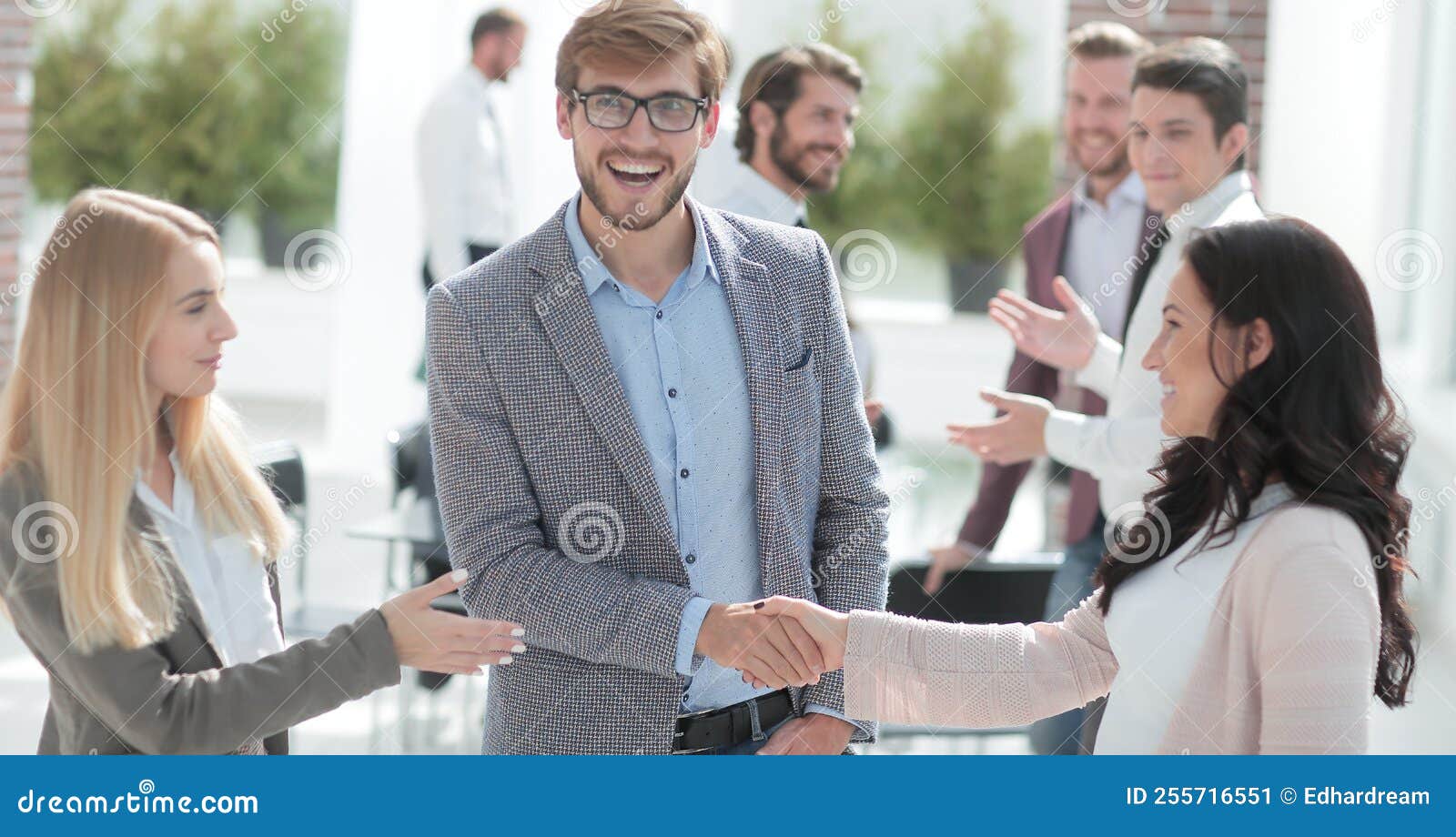 Smiling Manager Greeting the Customer in a Modern Office. Stock Image ...
