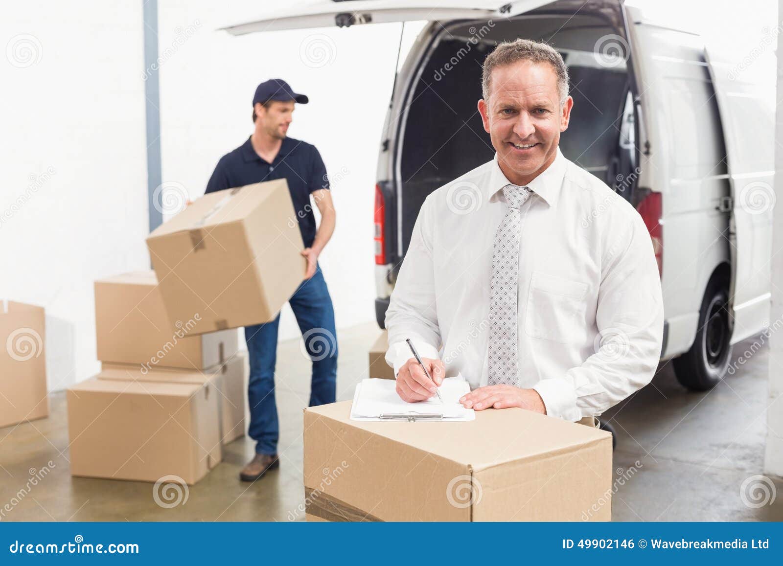 Smiling Manager Standing Behind Stack Cardboard Boxes Stock Photos ...