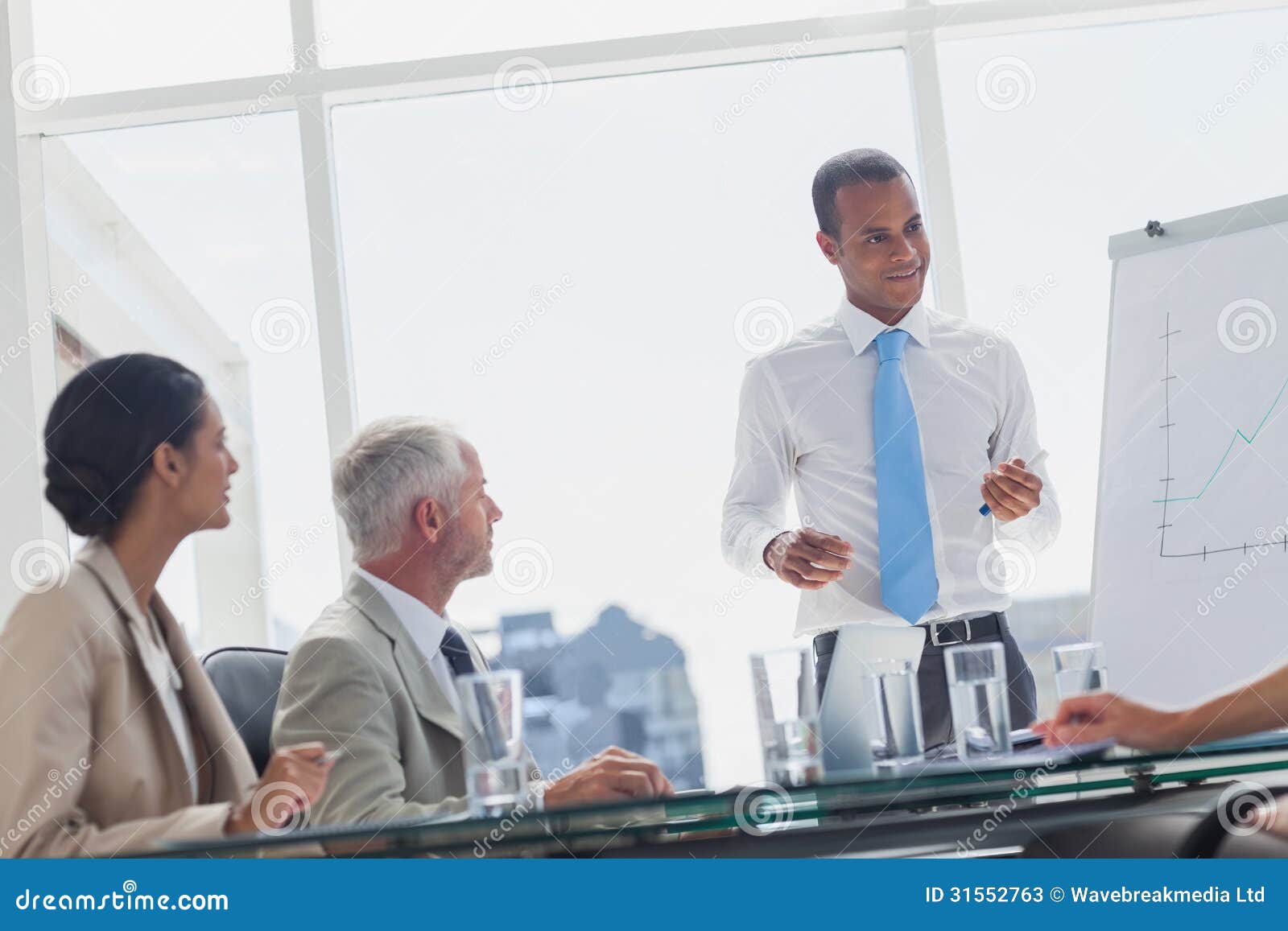 Smiling Manager Standing in Front of Colleagues Stock Image - Image of ...
