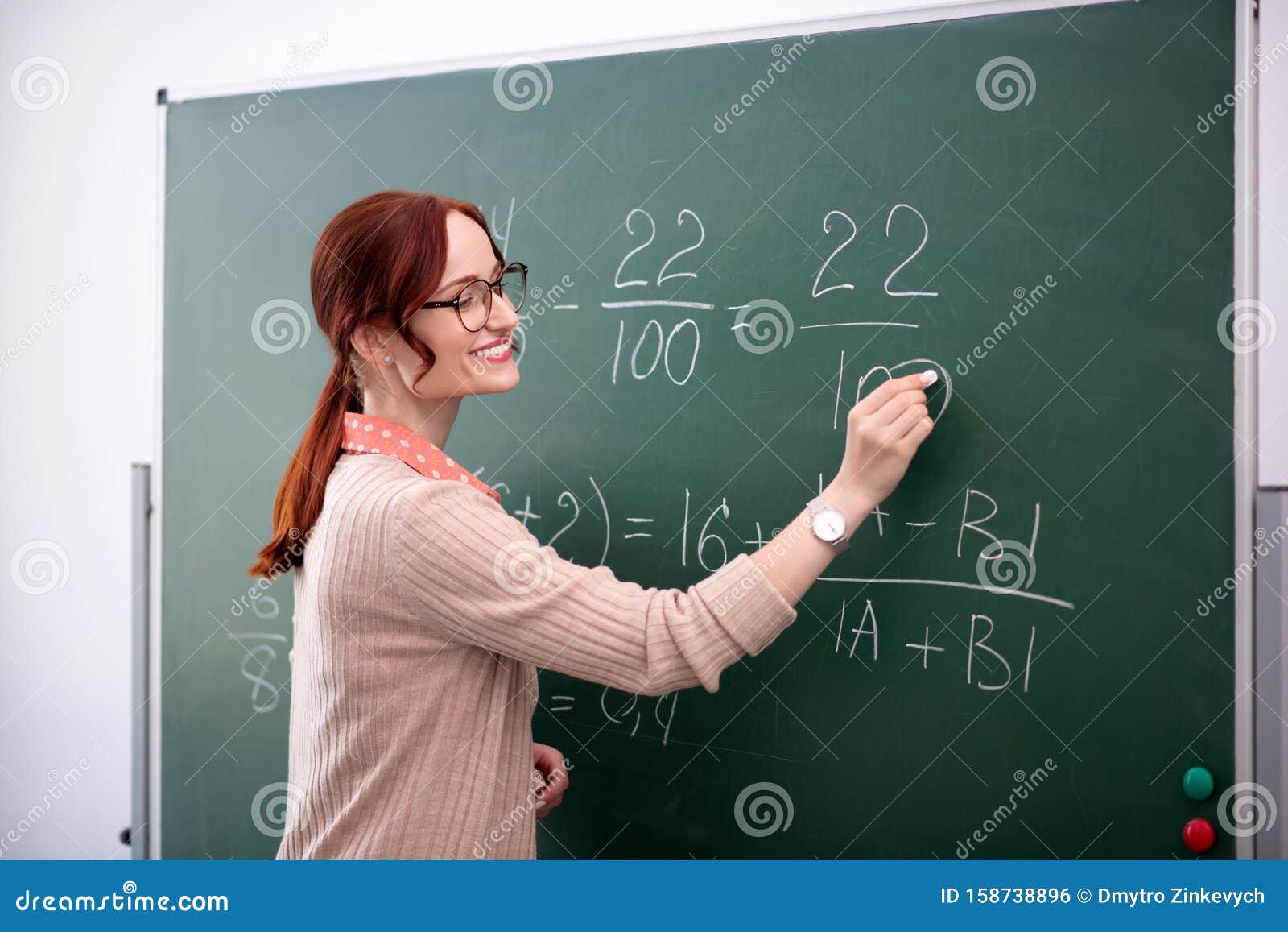 Smiling Math Teacher Explaining New Topic To Her Pupils Stock Photo ...