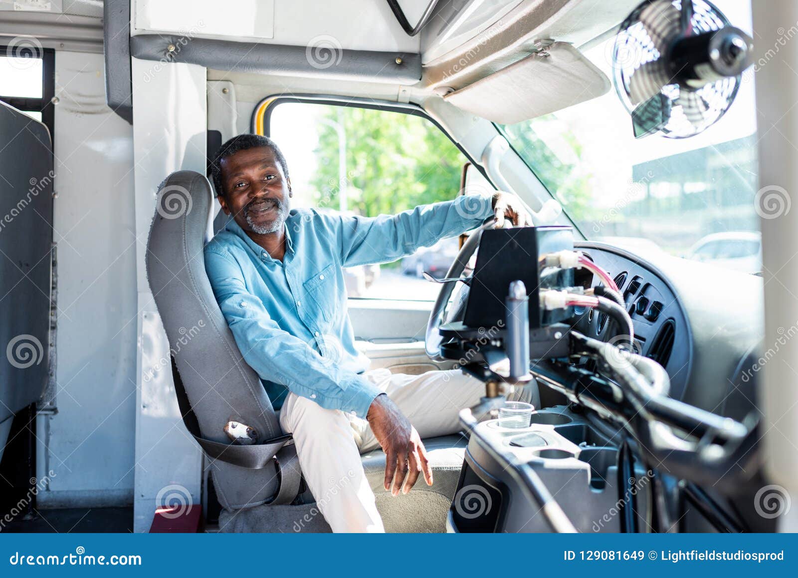 Smiling Mature African American Bus Driver Looking at Camera while ...