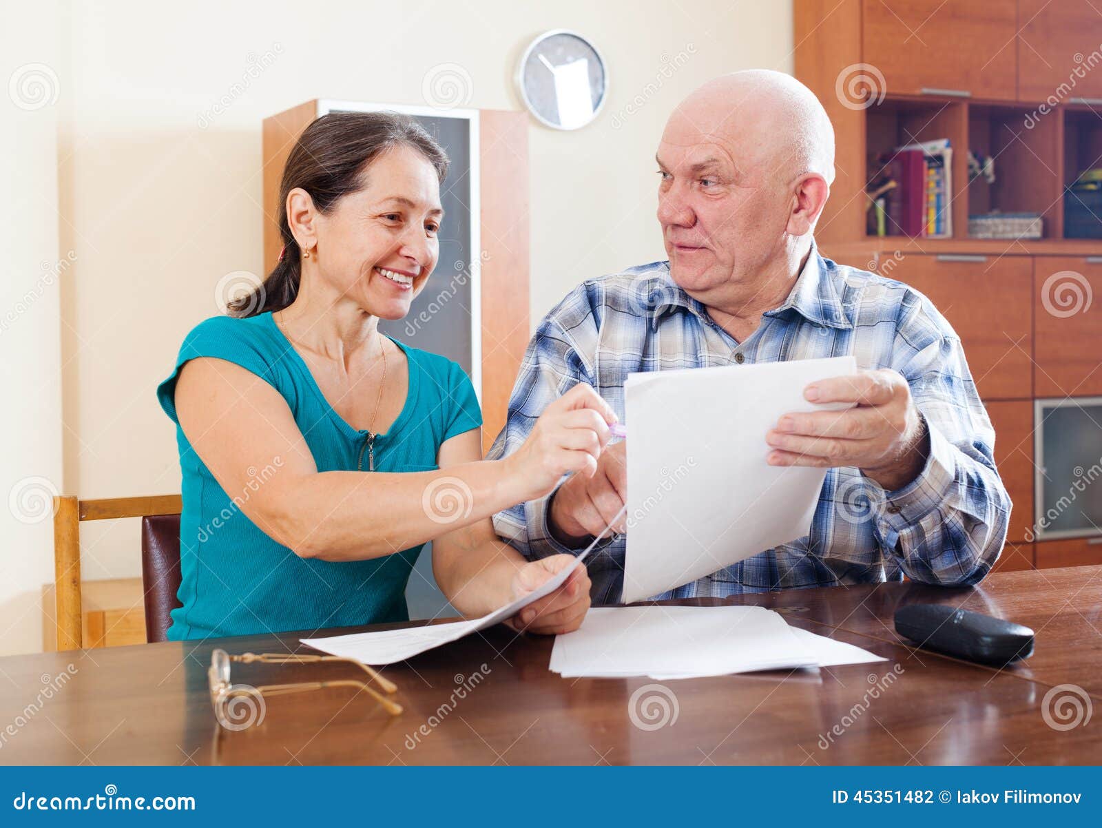 Smiling Mature Couple Reading Documents Stock Photo - Image of finance ...