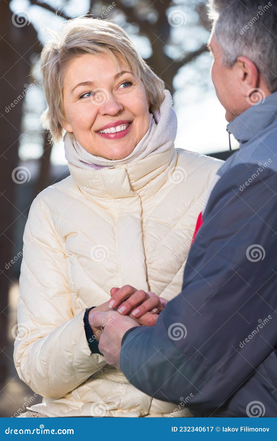 Smiling Mature Married Couple Holding Hands Each Other In Park Stock