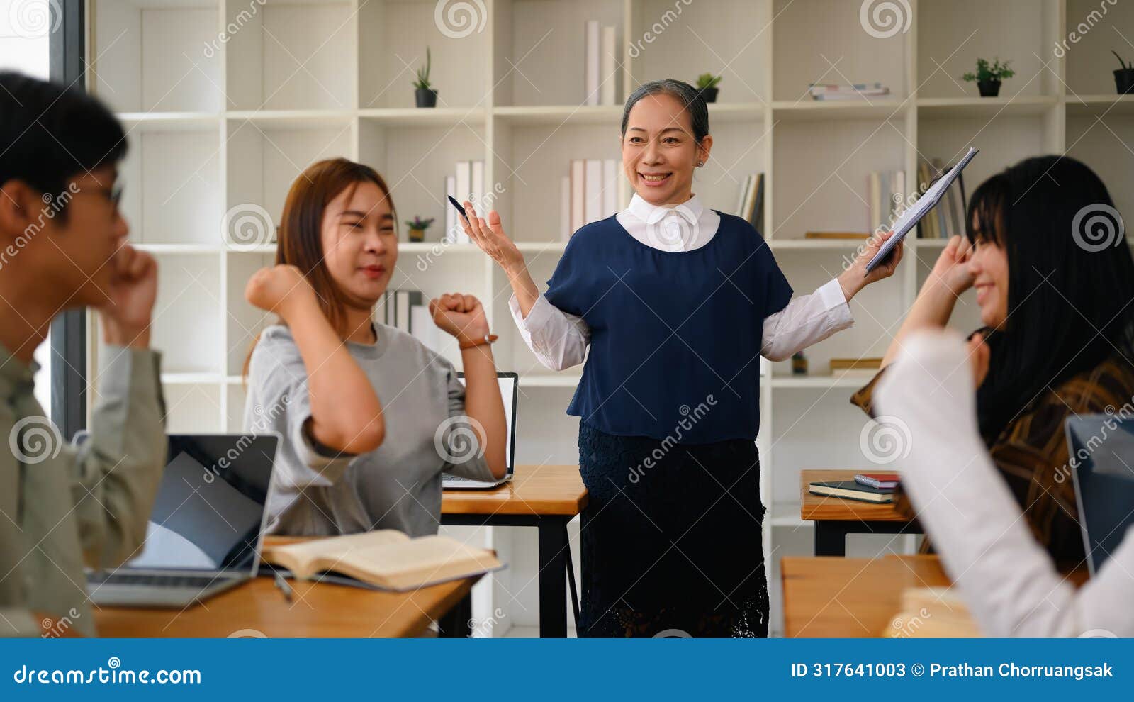 Smiling Mature Professor with Group of Students Celebrating Project ...