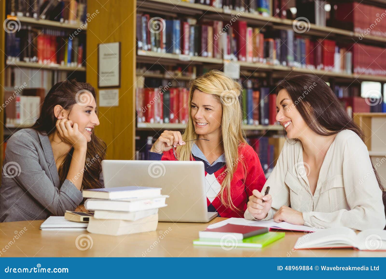 Smiling Mature Student with Classmates Using Laptop Stock Photo - Image ...