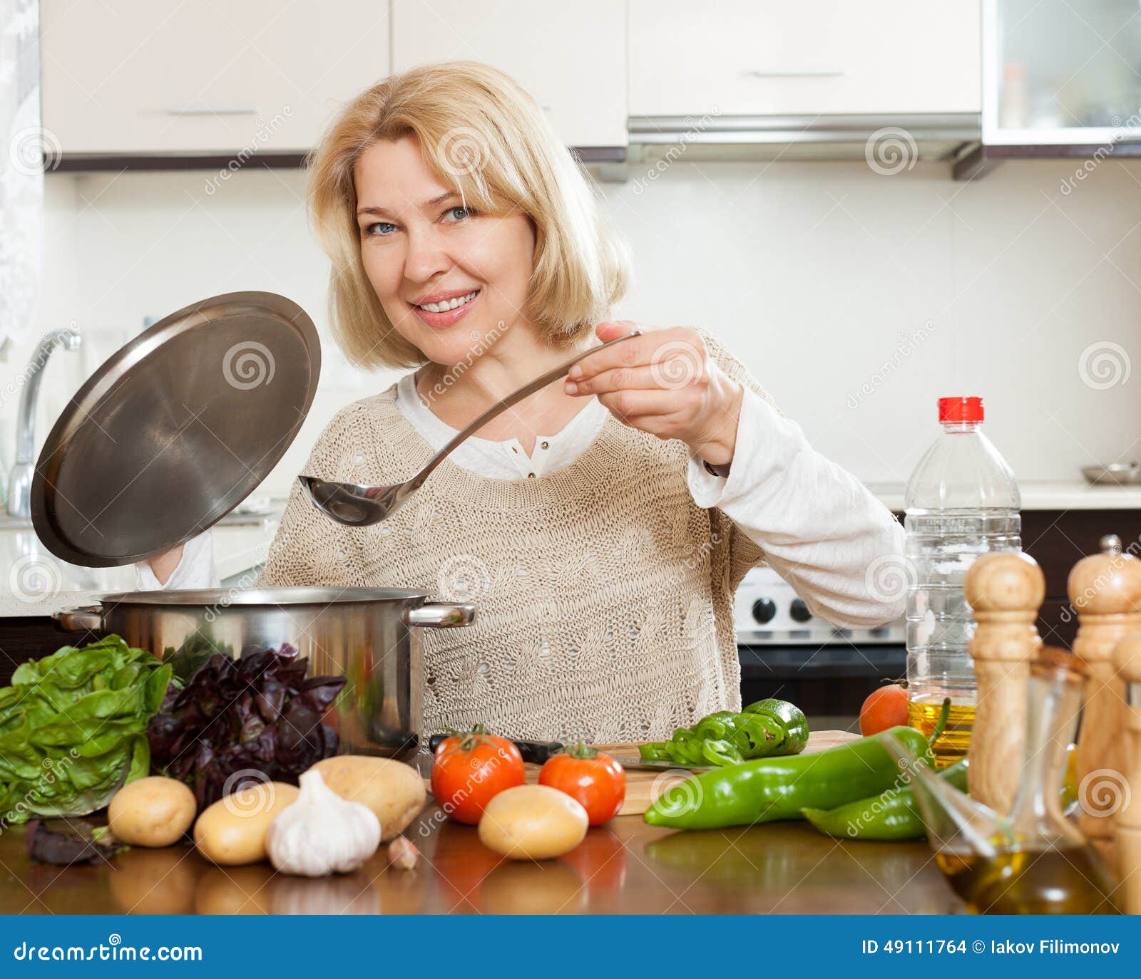 Smiling Mature Woman Cooking Soup Stock Photo - Image of ladle ...