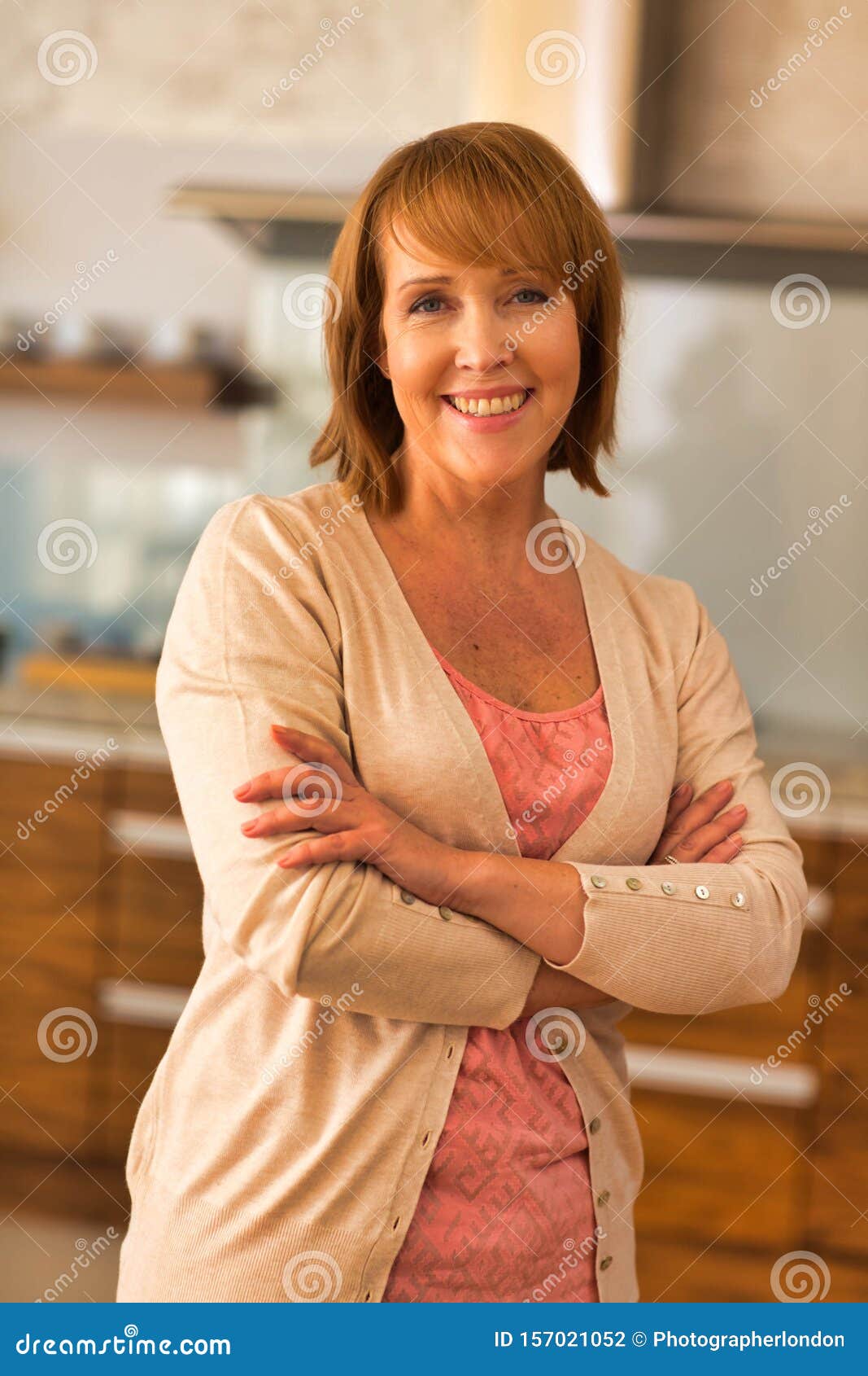 Portrait of Smiling Mature Woman Standing with Arms Crossed at Home ... Portrait of Smiling Mature Woman Standing with Arms Crossed at Home ...