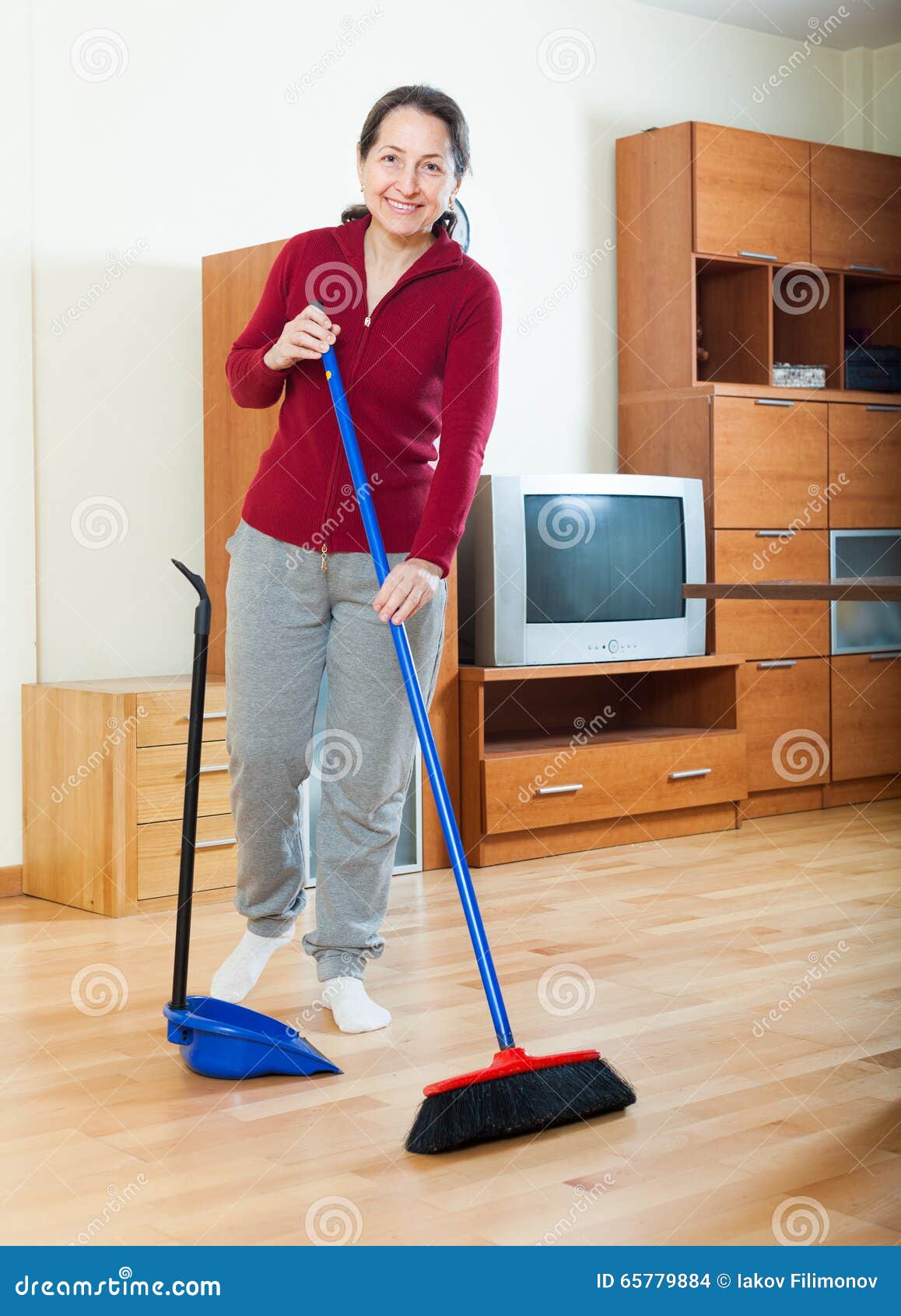 Smiling Mature Woman Sweeping the Floor Stock Photo - Image of broom ...