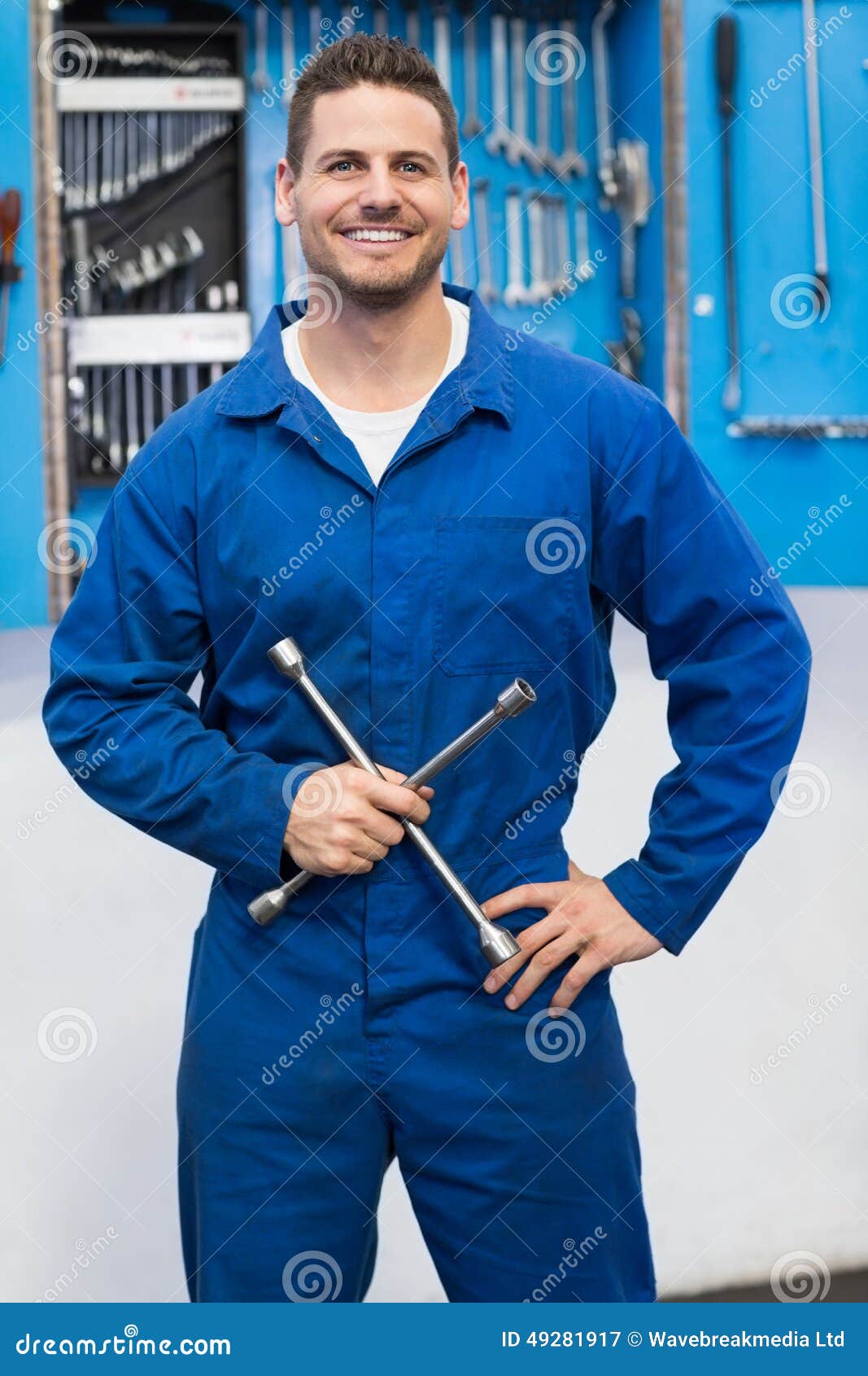 Smiling Mechanic Looking at Camera Stock Image - Image of wrench, blue ...