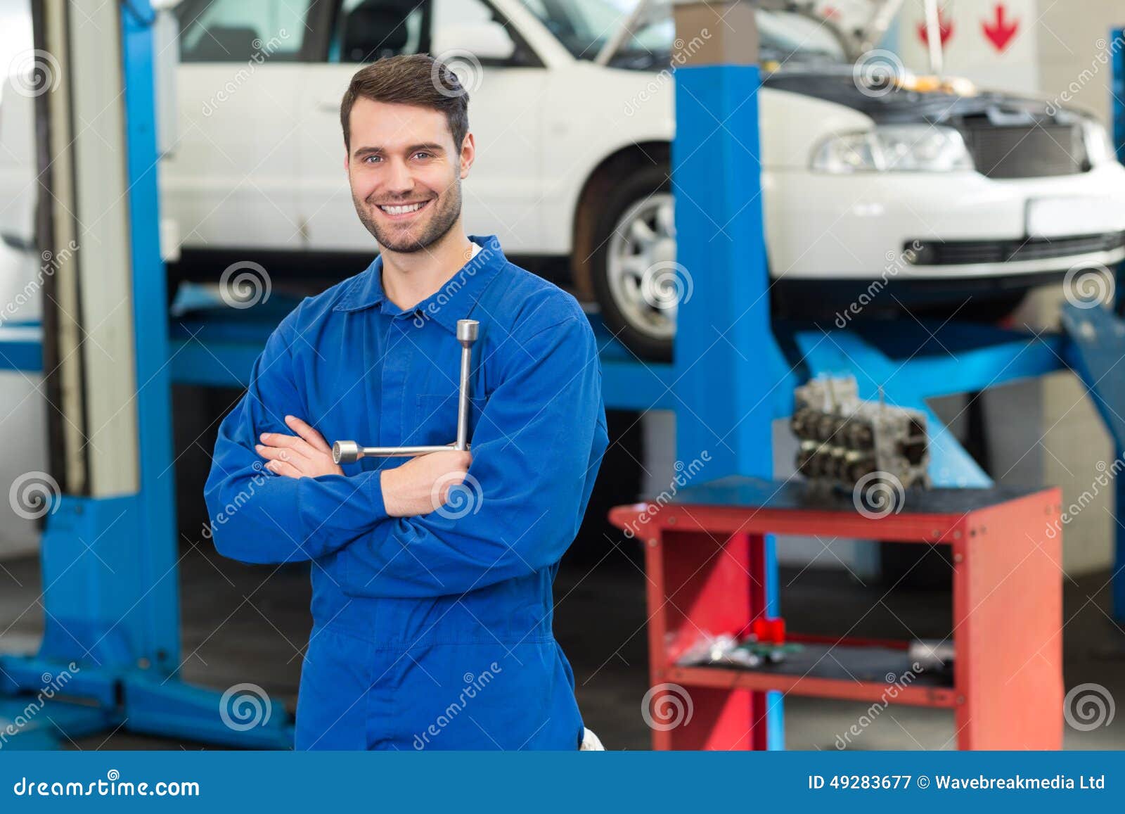 Smiling Mechanic Looking at Camera Stock Image - Image of adult, blue ...
