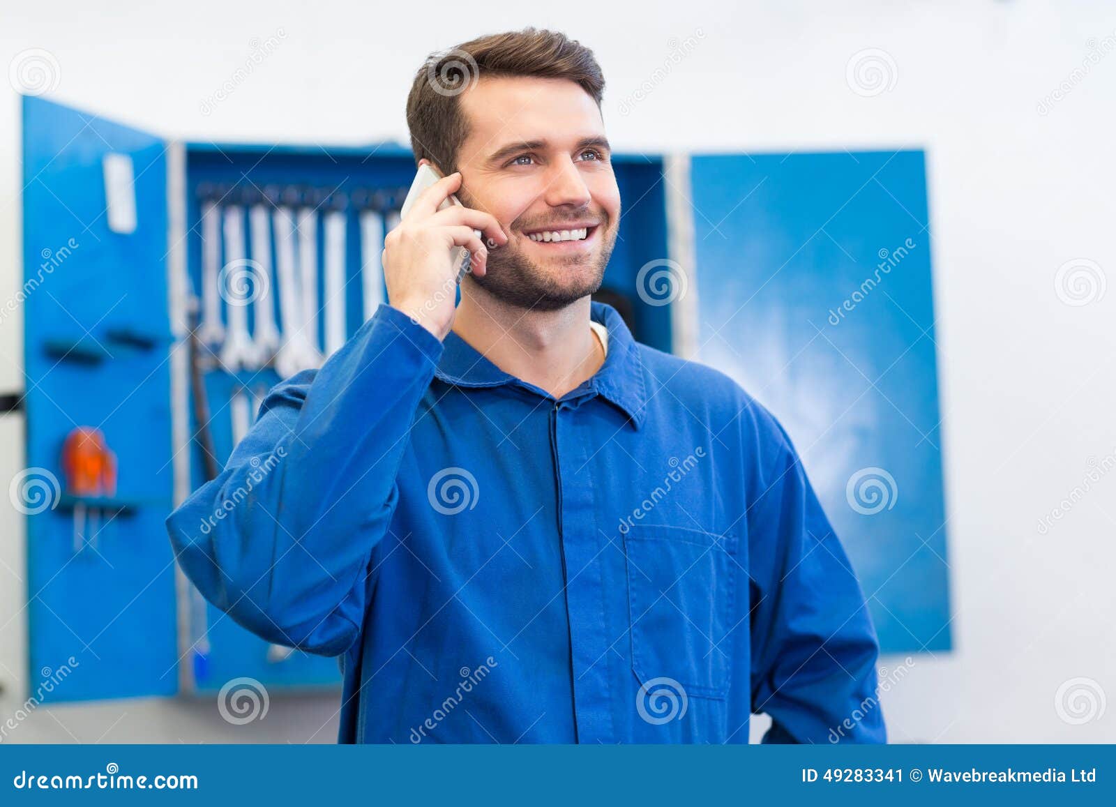 Smiling Mechanic on the Phone Stock Image - Image of indoors ...