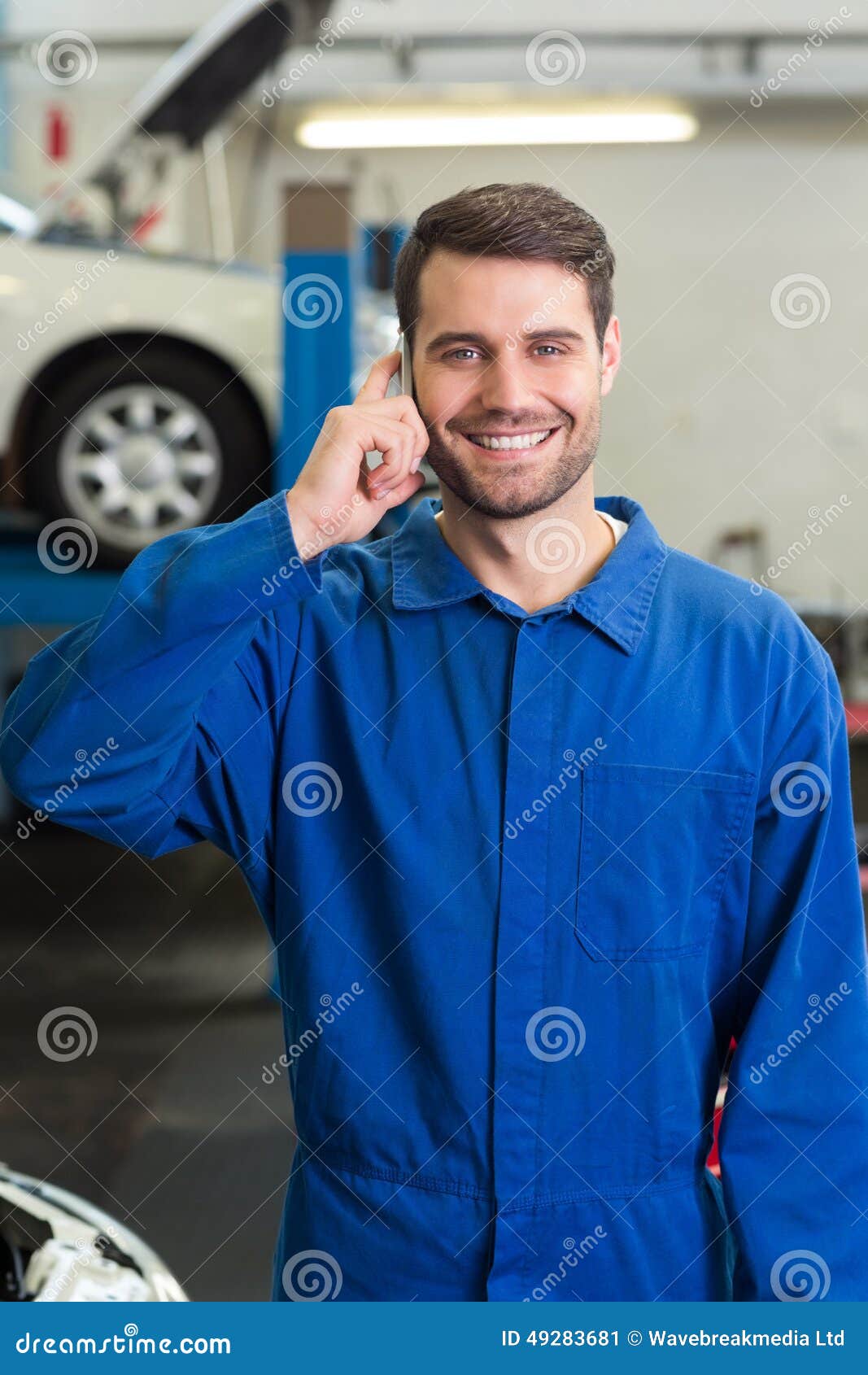 Smiling Mechanic on the Phone Stock Image - Image of engineer, holding ...