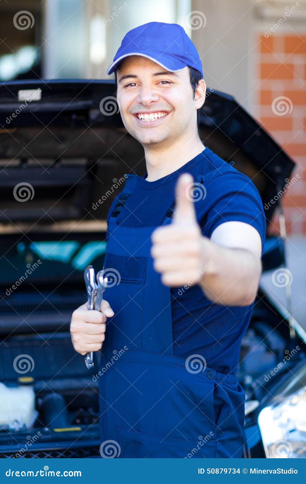 Smiling mechanic thumbs up stock photo. Image of garage - 50879734