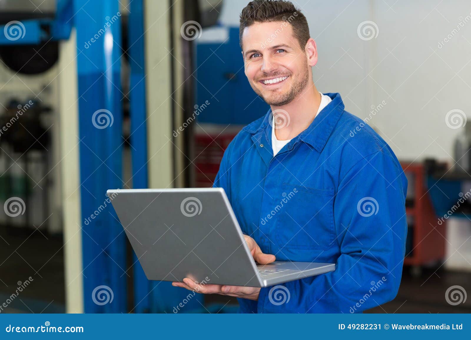 Smiling Mechanic Using His Laptop Stock Image - Image of typing ...