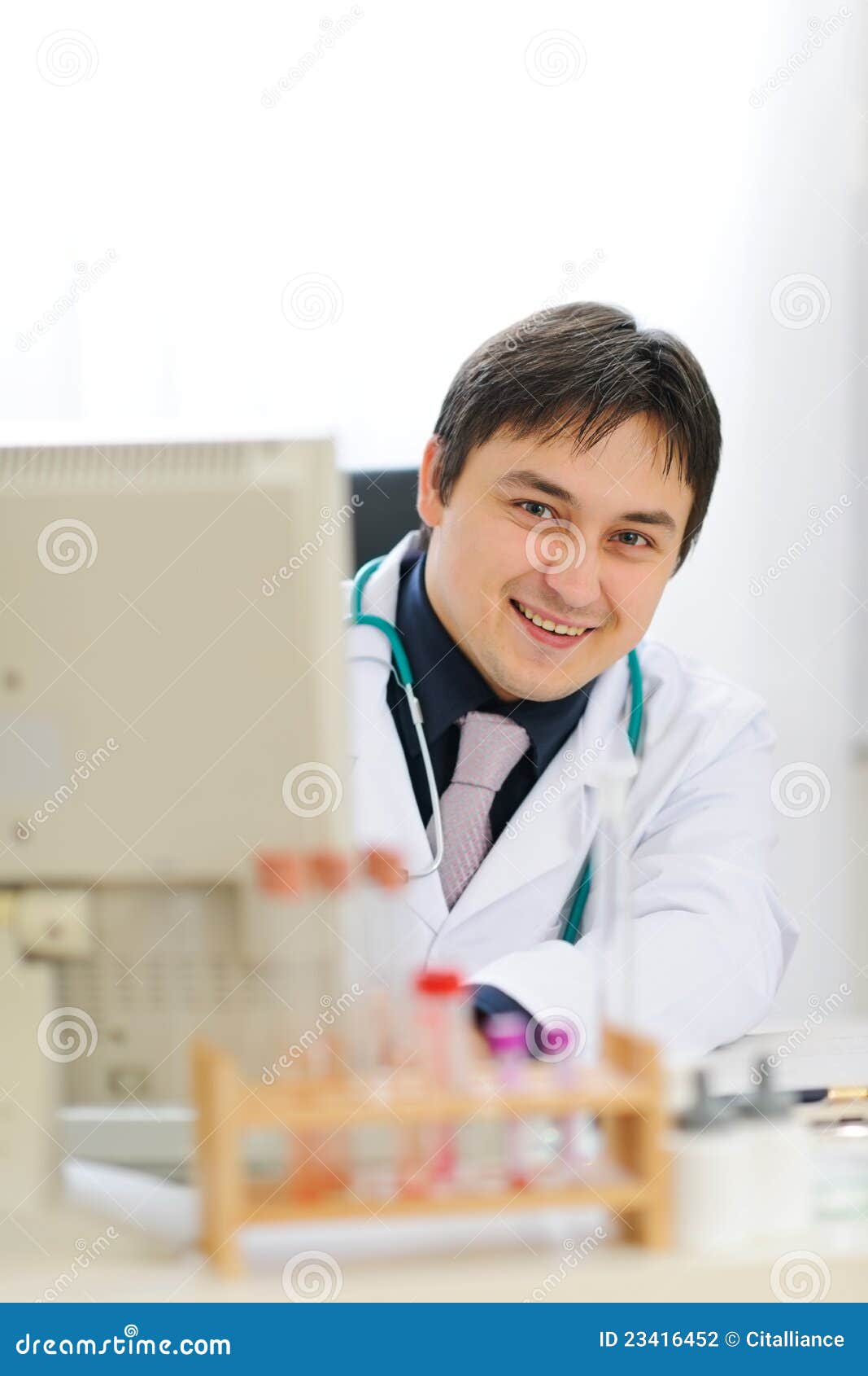 Smiling Medical Doctor Looking Out from Computer Stock Photo - Image of ...