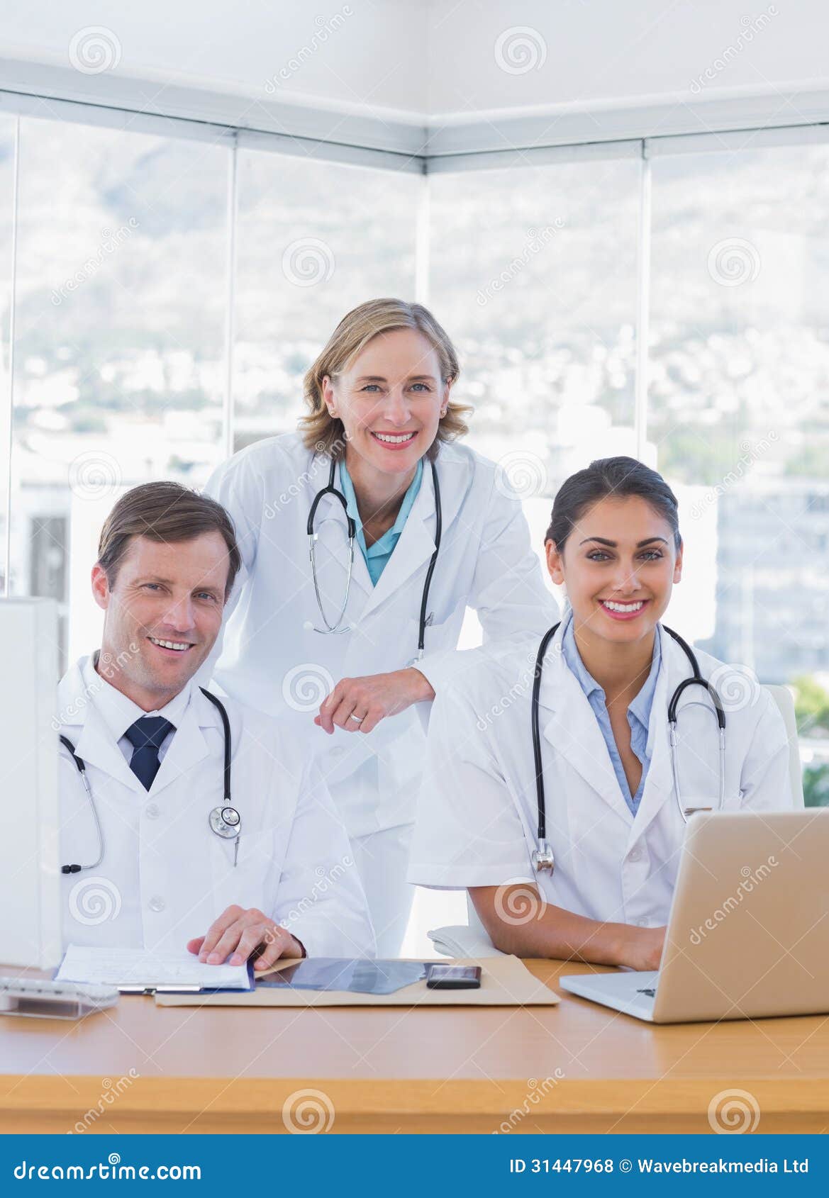 Smiling Medical Staff Working on a Laptop and a Computer Stock Photo ...