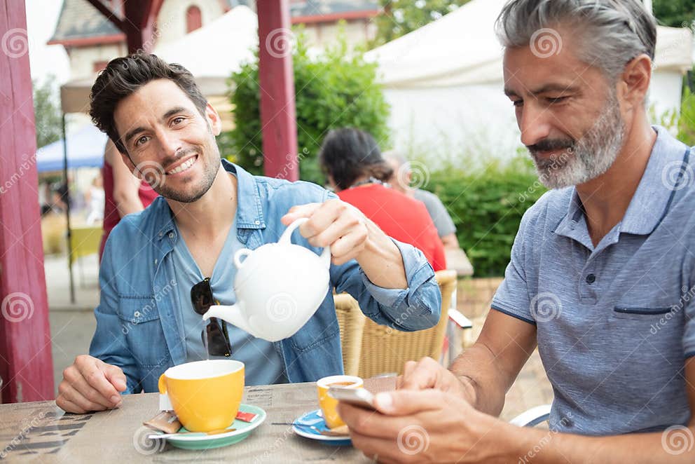 Smiling Men Drinking Tea Outdoors Stock Image - Image of couple, family ...