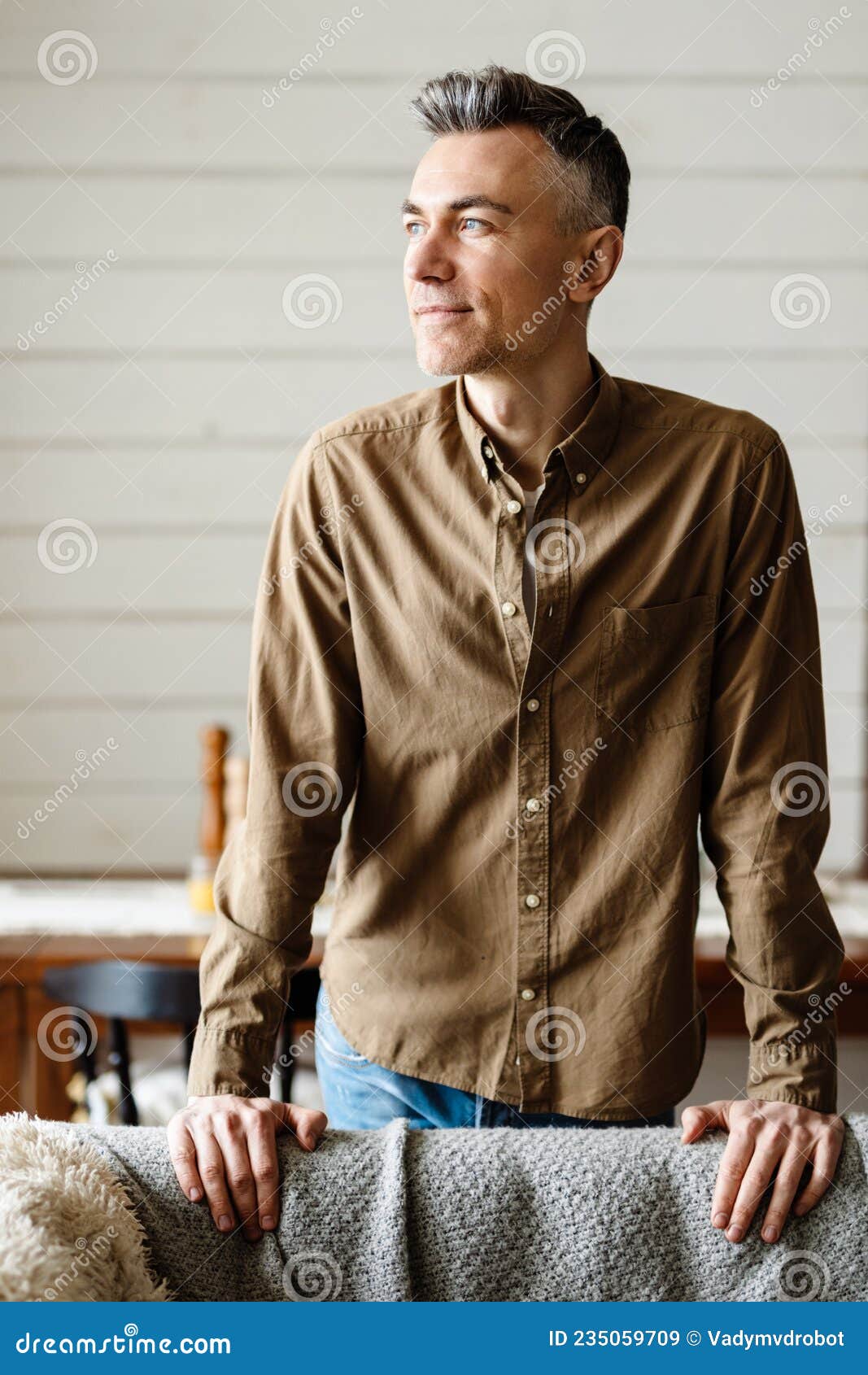 Smiling Mid Aged Man Leaning on a Couch Standing Stock Image - Image of ...