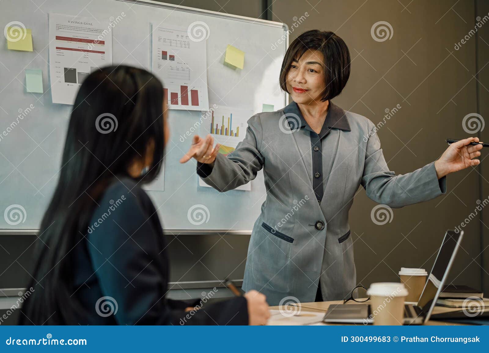 Smiling Middle Age Female Coach Asking Question during Presentation ...