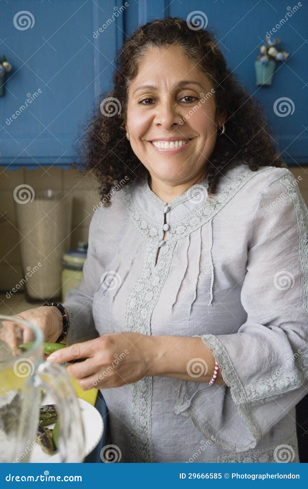 Smiling Middle-aged Woman Cooking in Kitchen Stock Image - Image of ...
