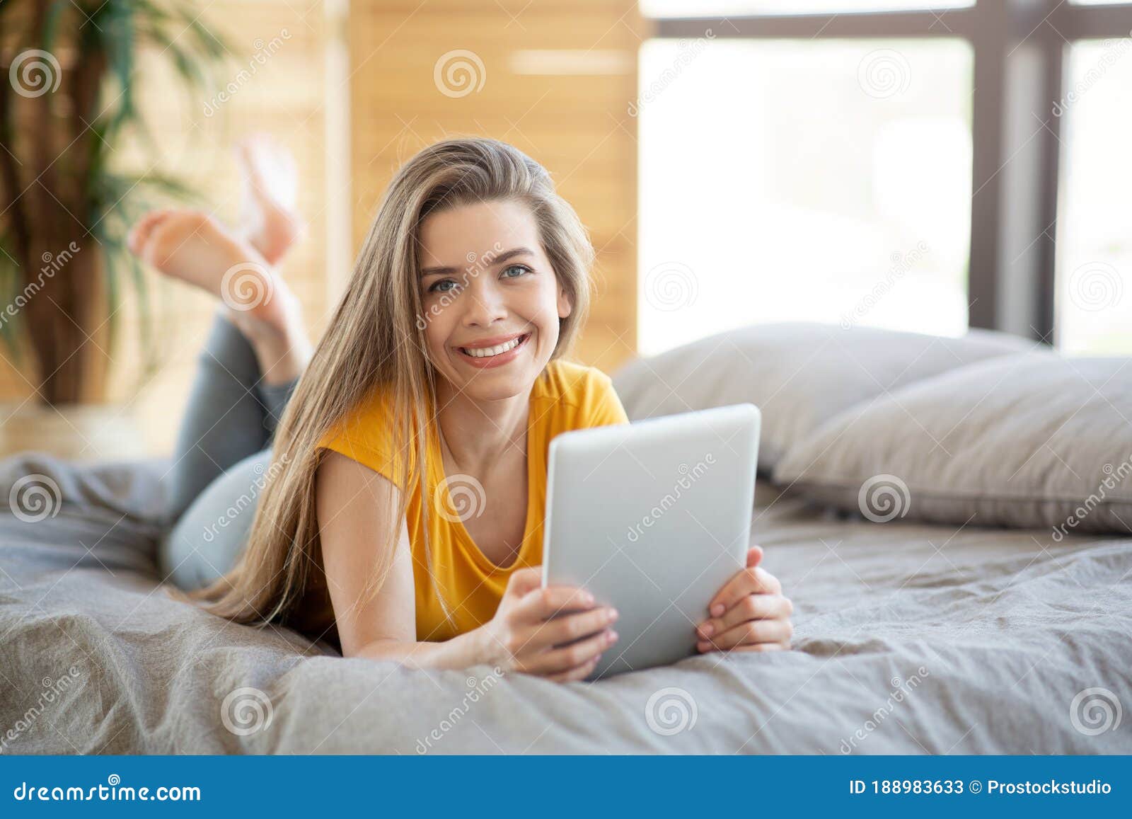 Smiling Millennial Woman Using Tablet Computer for Online Work or ...