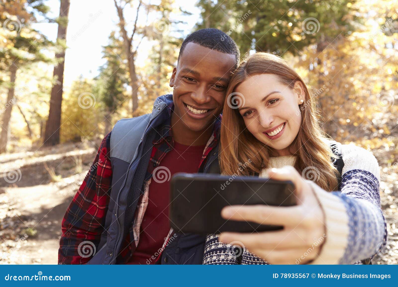 Smiling Mixed Race Couple Take A Selfie In A Forest Stock Image Image