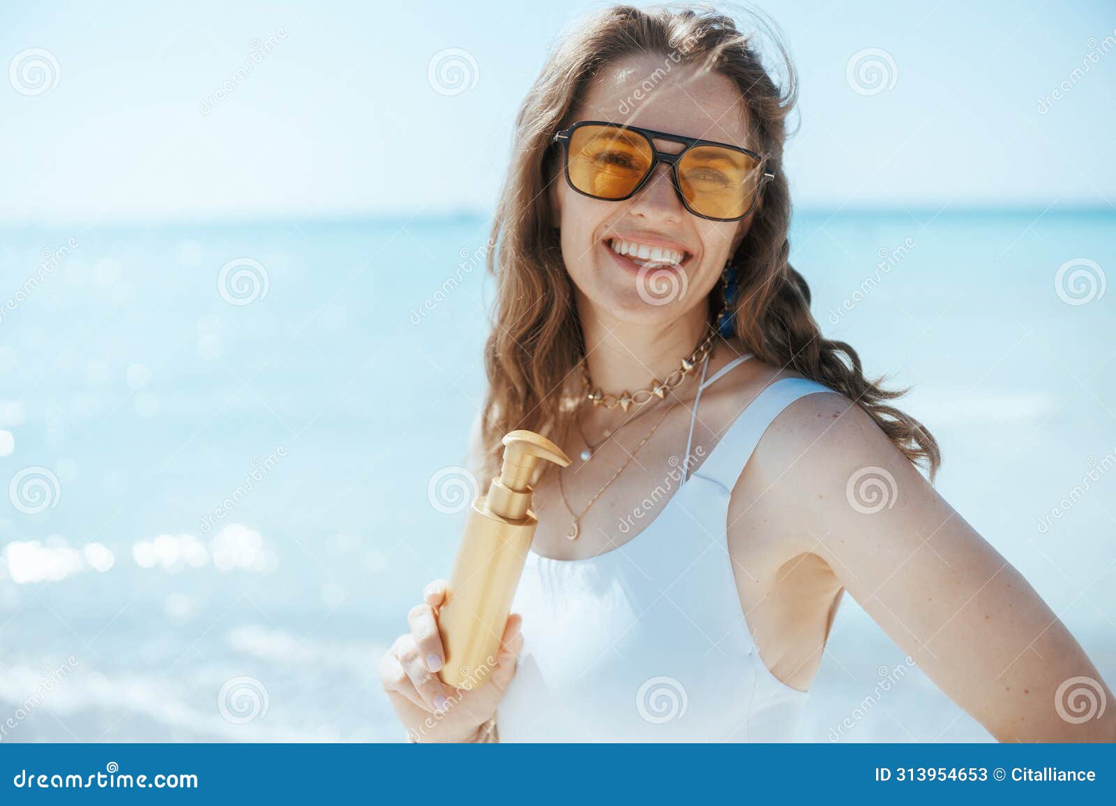Smiling Modern Female on Ocean Coast with Sunscreen Stock Image - Image ...