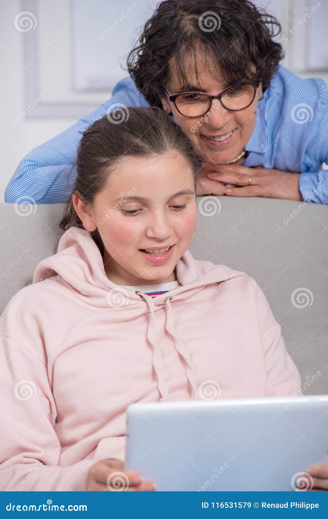 Smiling Mom and Daughter Using Tablet Computer at Home Stock Image ... Smiling Mom and Daughter Using Tablet Computer at Home Stock Image ...