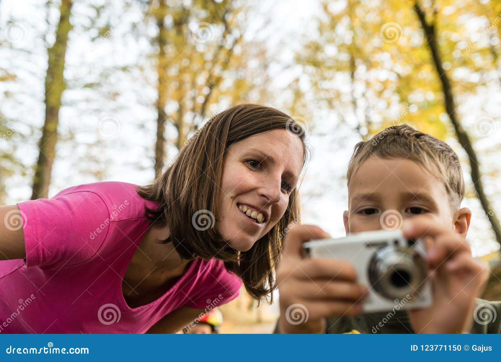 Smiling Mother Looking at an Image on a Camera Held by Her Young Stock ...