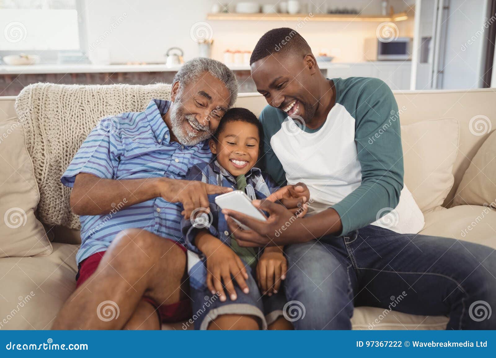 Smiling Multi-generation Family Using Mobile Phone in Living Room Stock ...