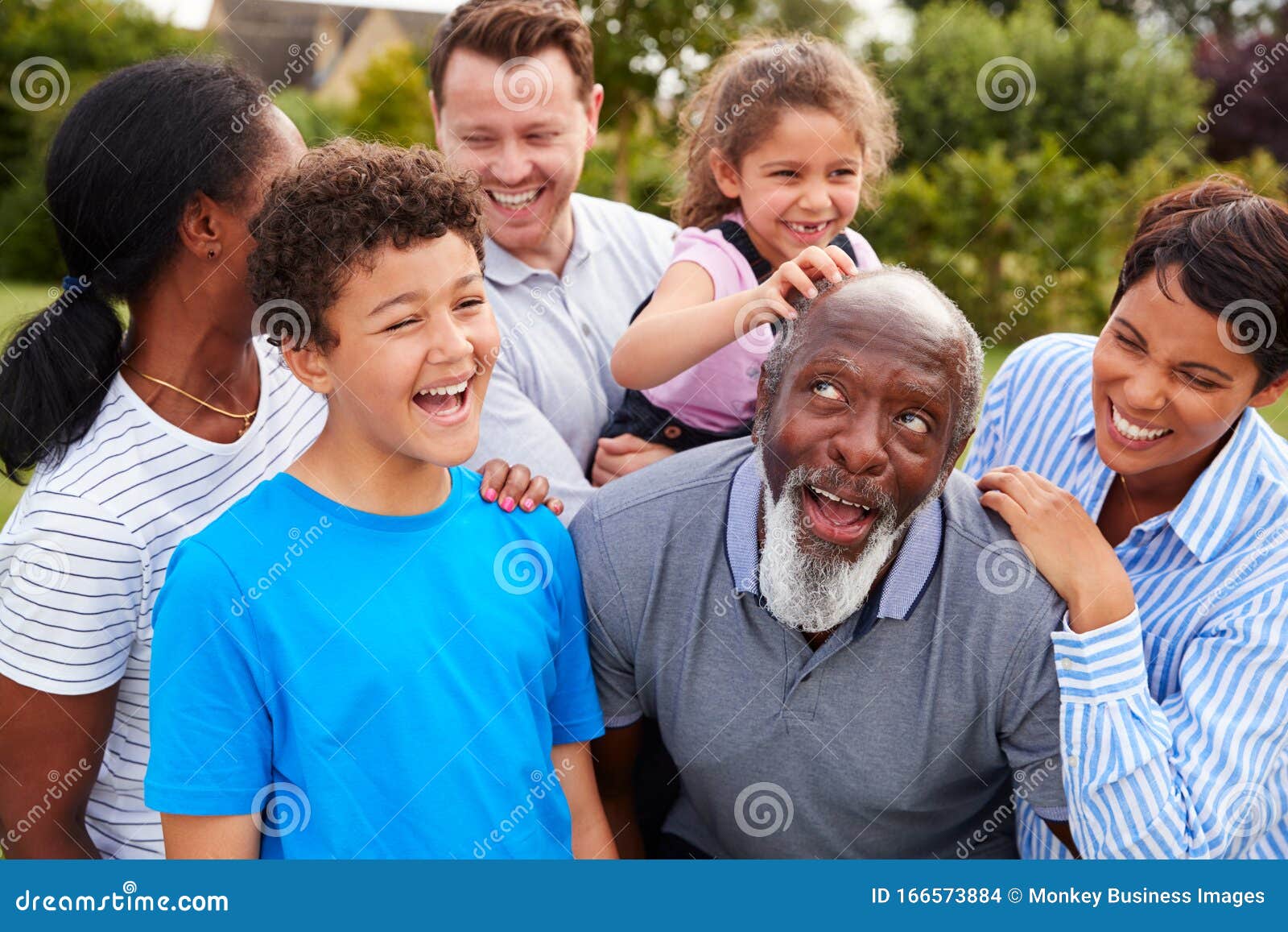 Smiling Multi-Generation Mixed Race Family Having Fun in Garden at Home ...