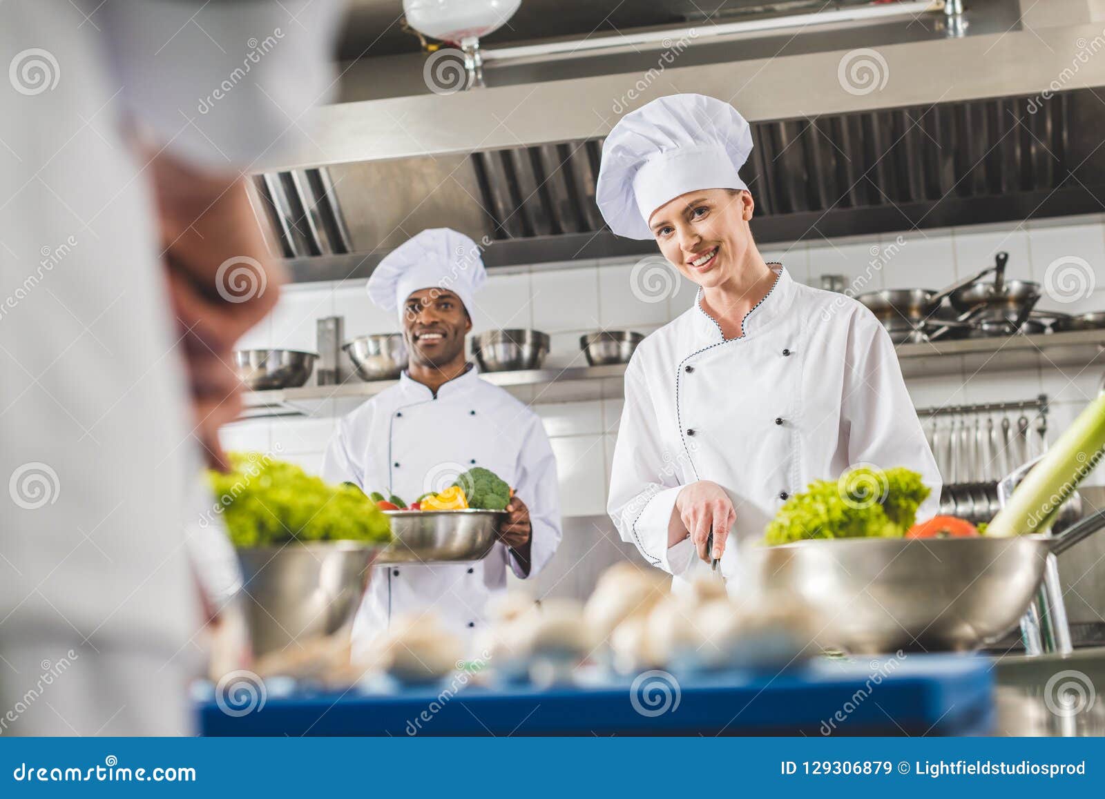 Smiling Multicultural Chefs Preparing Food at Restaurant Kitchen and ...