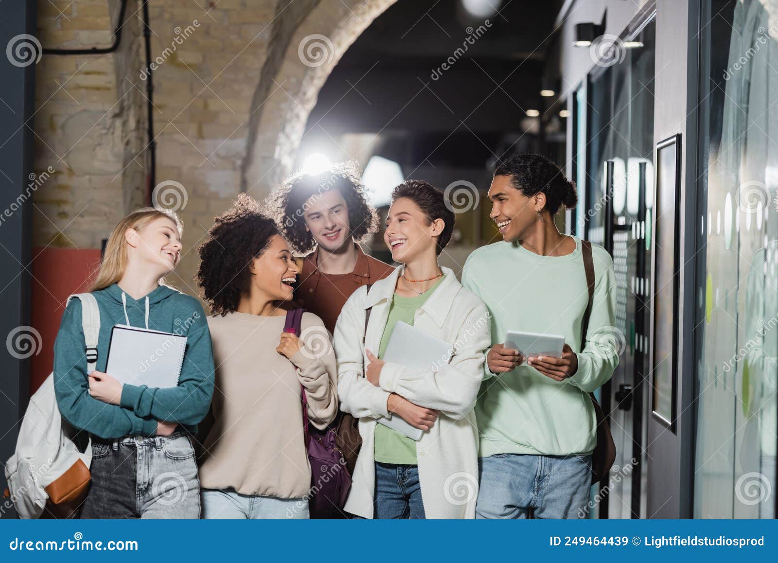 Smiling Multicultural Classmates Walking Along Hallway Stock Image ...