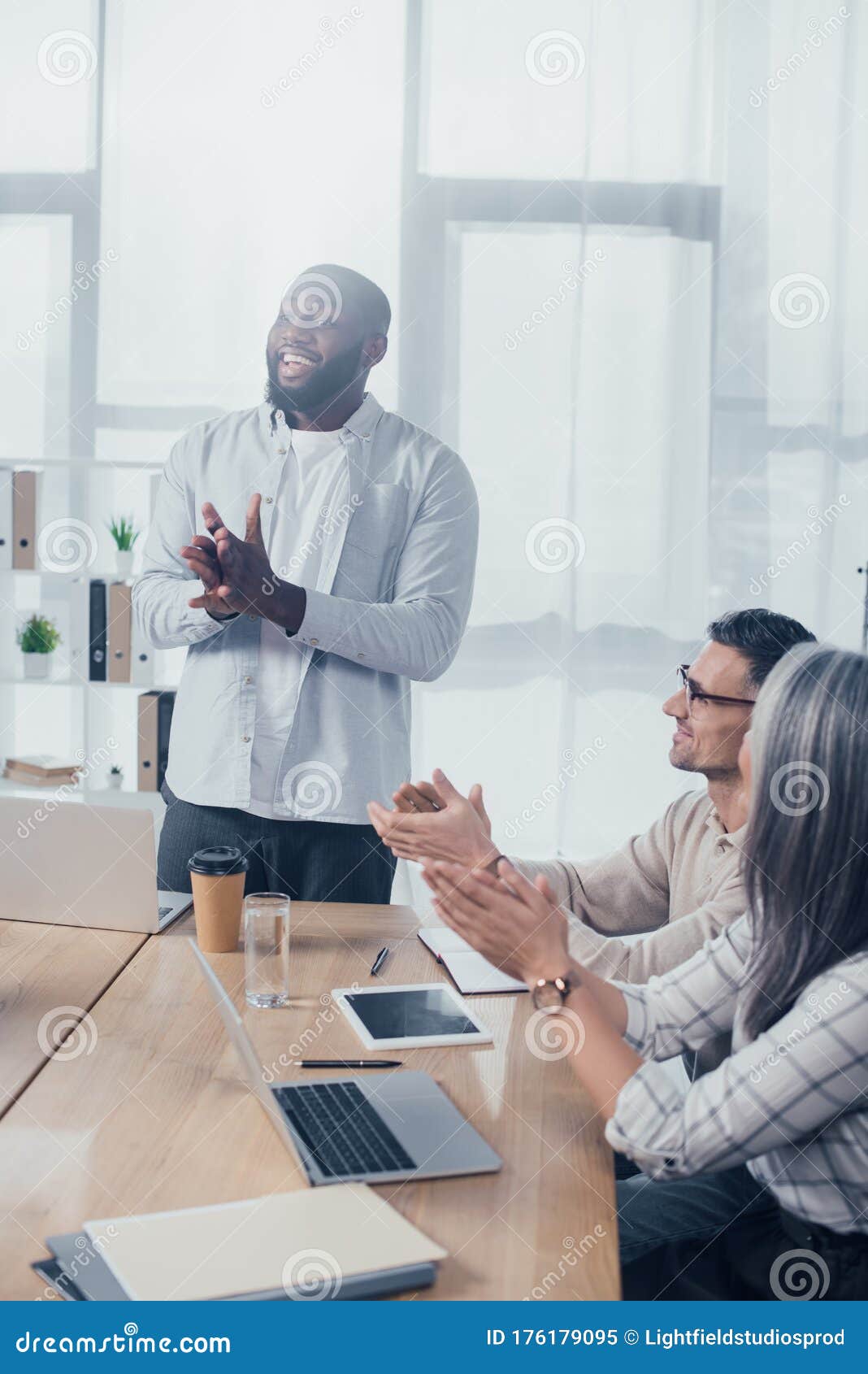 Multicultural Colleagues Clapping during Meeting in Stock Image - Image ...