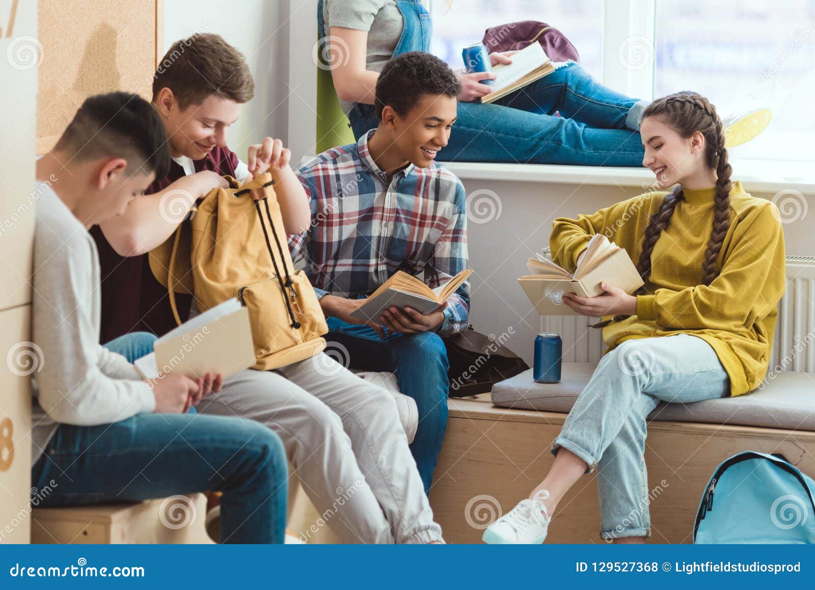 Smiling Multicultural High School Pupils Reading Books and Talking ...