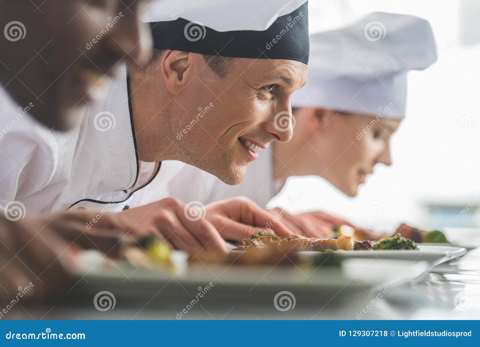Smiling Multiethnic Chefs Sniffing Cooked Food at Restaurant Stock ...