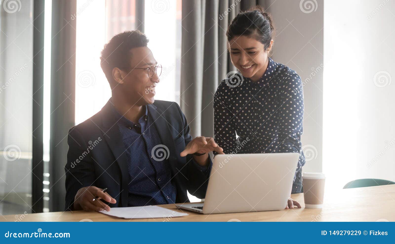Smiling Multiethnic Diverse Colleagues Talk Cooperating at Laptop Stock ...