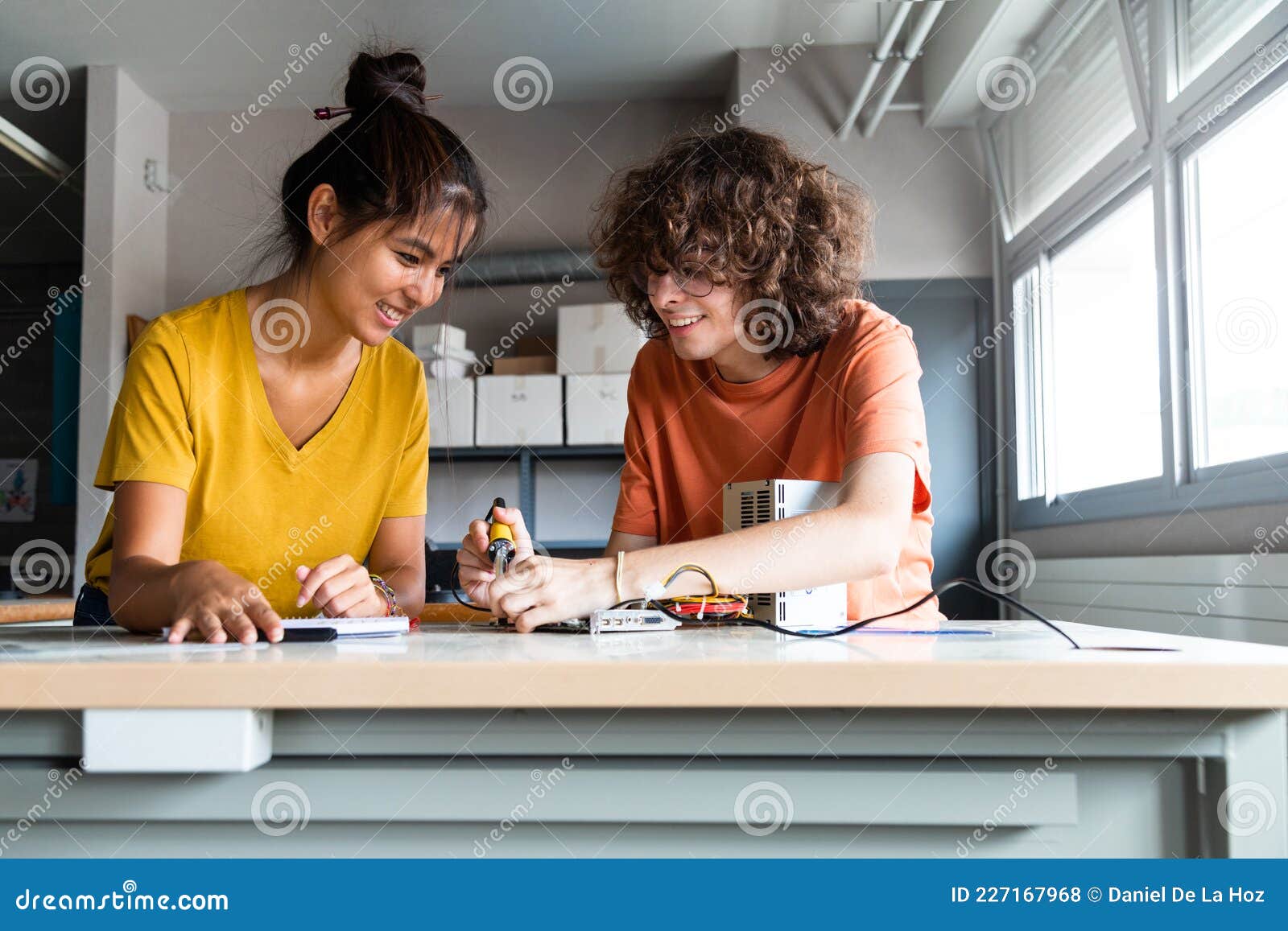 Smiling Multiracial Teen High School Students Working on a Project in ...