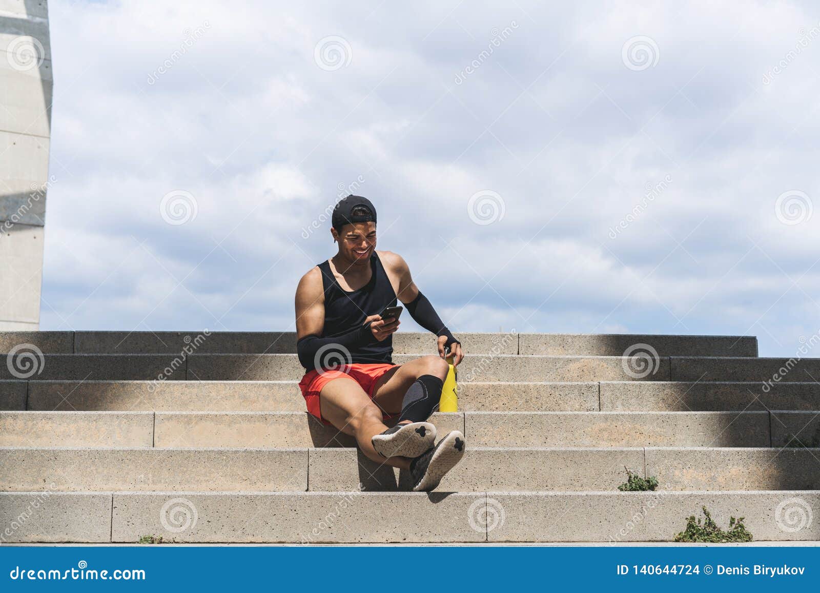 Smiling Muscular Fit Sport Model Sprinter Resting after His Workout and ...