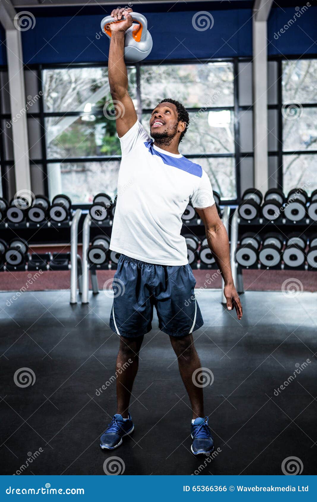Smiling Muscular Man Lifting Kettlebells Stock Photo - Image of athlete ...