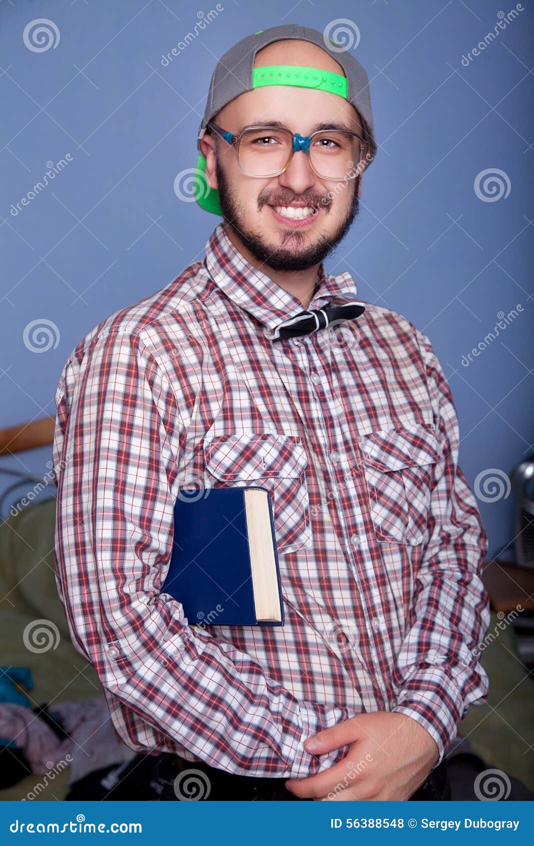 Smiling nerd with a book stock photo. Image of student - 56388548